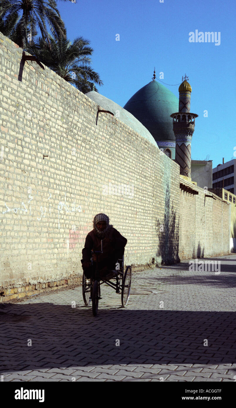 Man in wheel chair by Mosque Central area Baghdad Iraq Stock Photo - Alamy