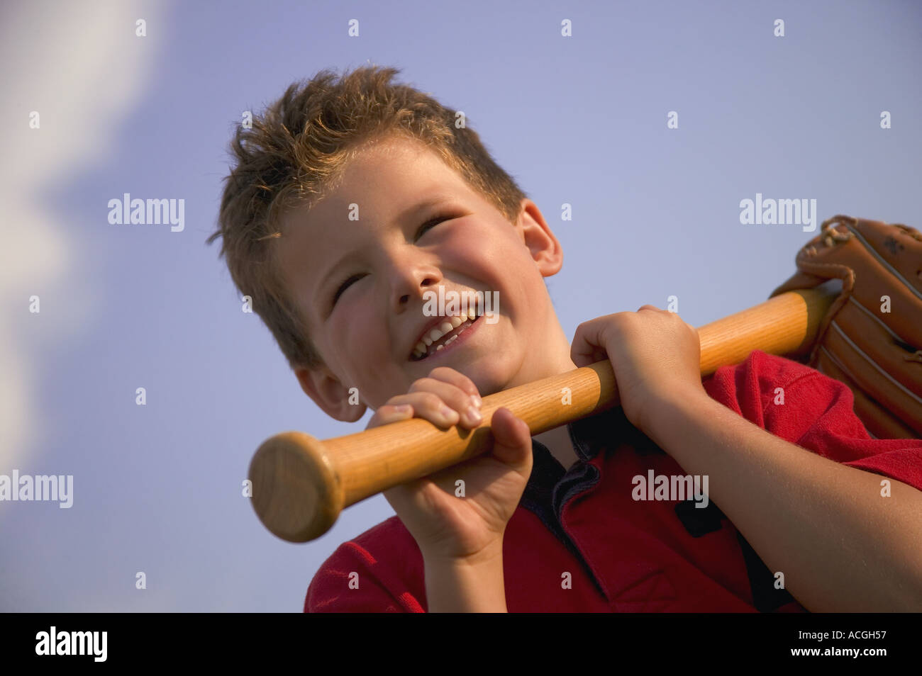 Smiling boy with a baseball bat Stock Photo - Alamy