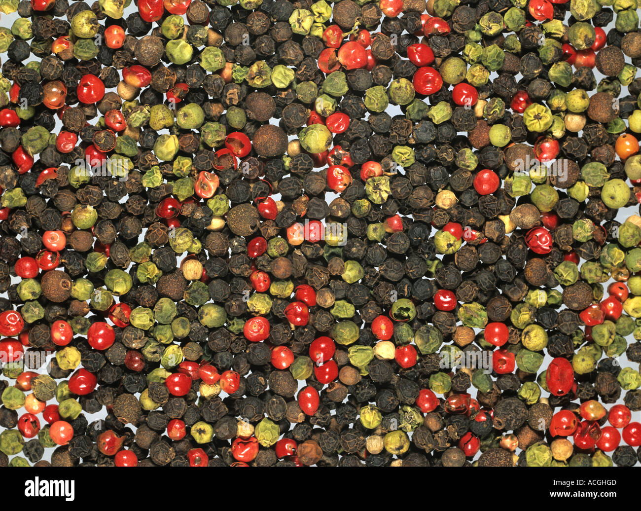 Mixed pepper seeds of various colours red black green Stock Photo - Alamy