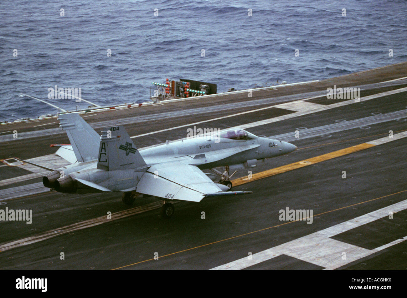 Flight deck officers land a U.S. Navy F/A-18C Hornet during flight ...