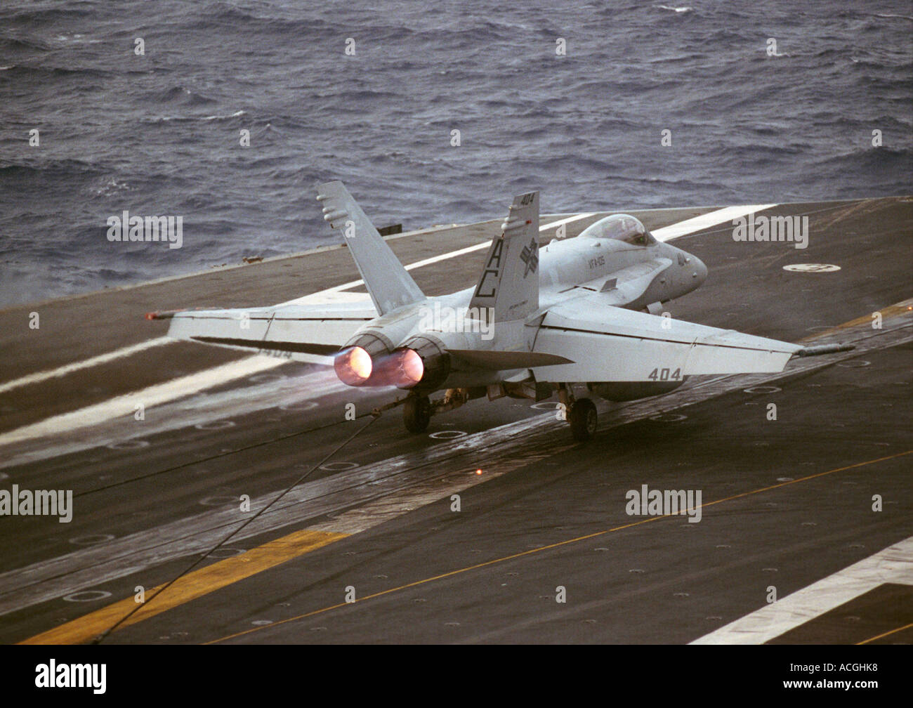 a U.S. Navy F/A-18C Hornet lands during flight operations from the deck ...