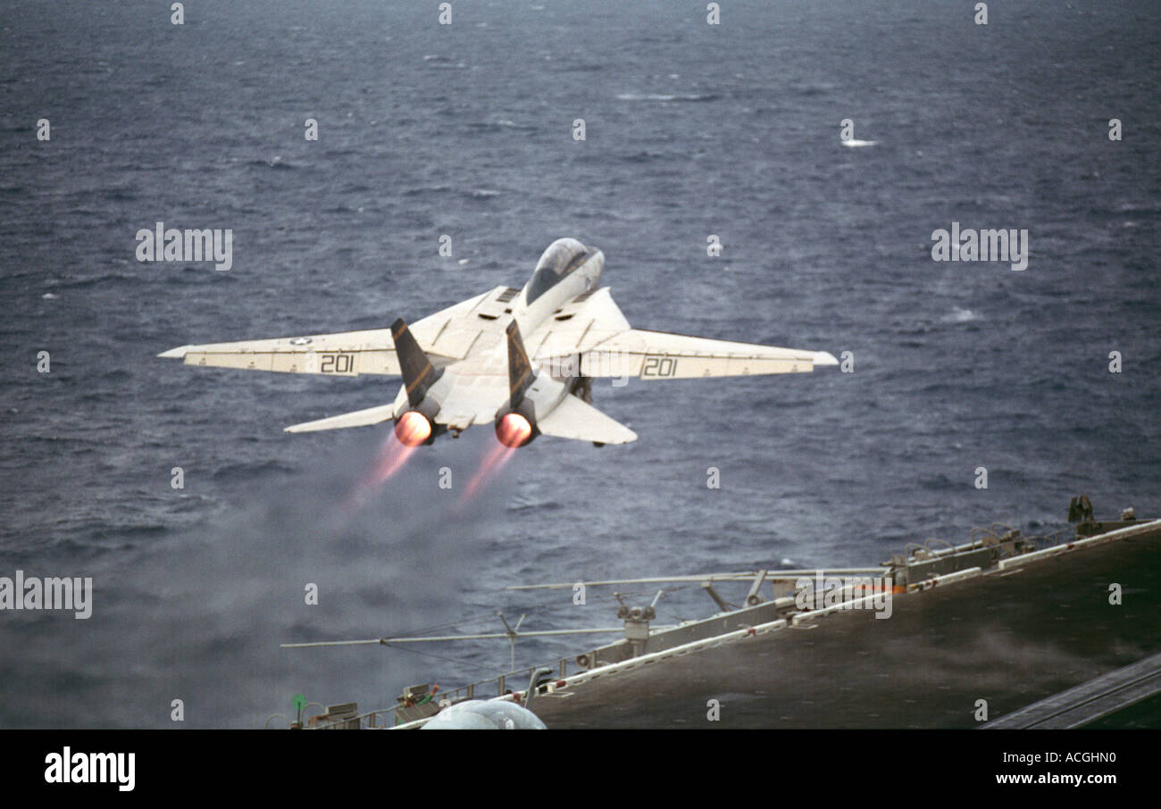 Flight deck officers launch a U.S. Navy F/A-18C Hornet during flight ...