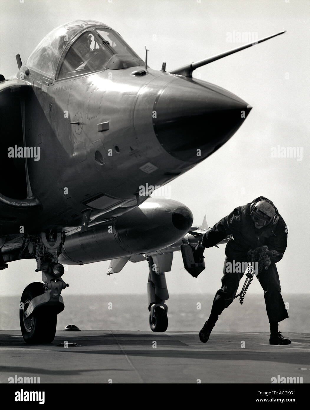 Aircraft handler removes chocks fron Sea Harrier aboard HMS Ark Royal ...