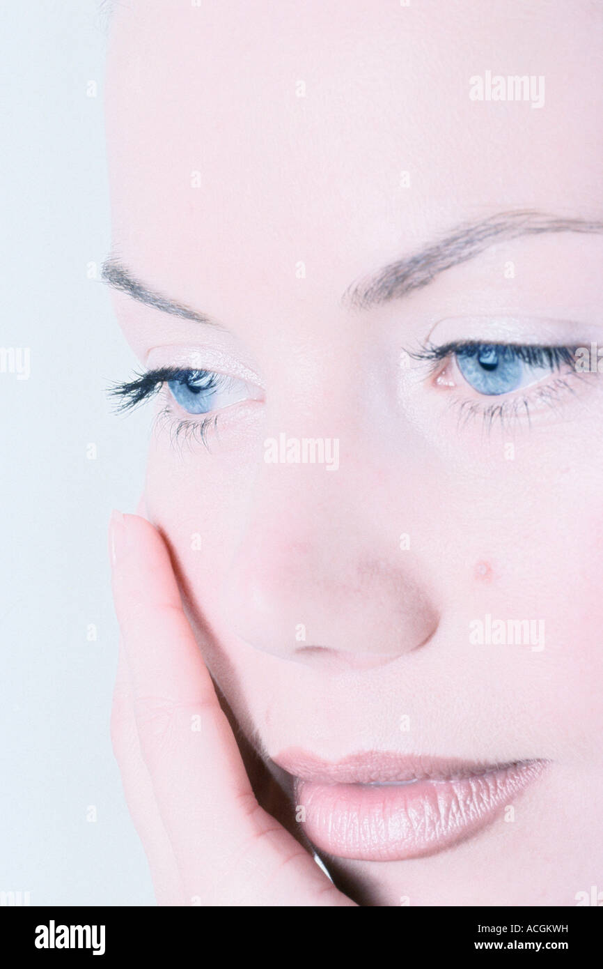 Portrait woman thoughtful hands on cheek Stock Photo - Alamy