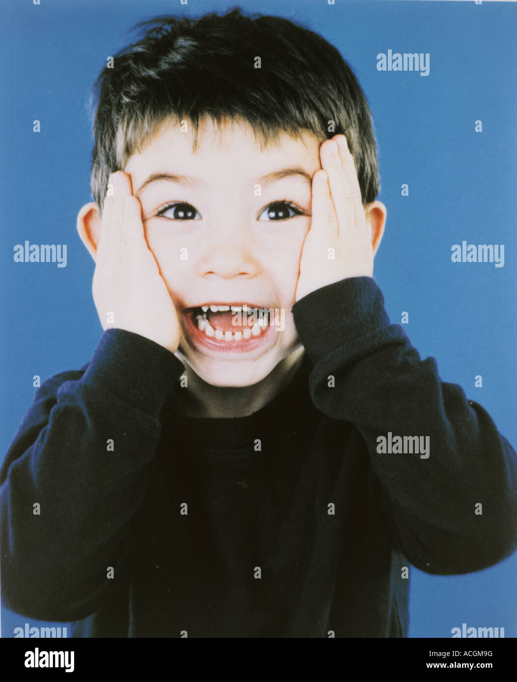 Child laughing hands on cheeks Stock Photo - Alamy
