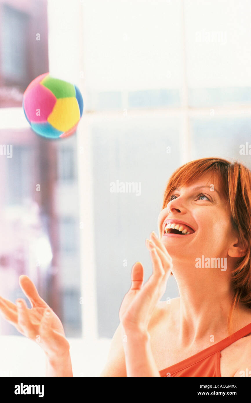 Portrait smiling woman throwing ball Stock Photo - Alamy