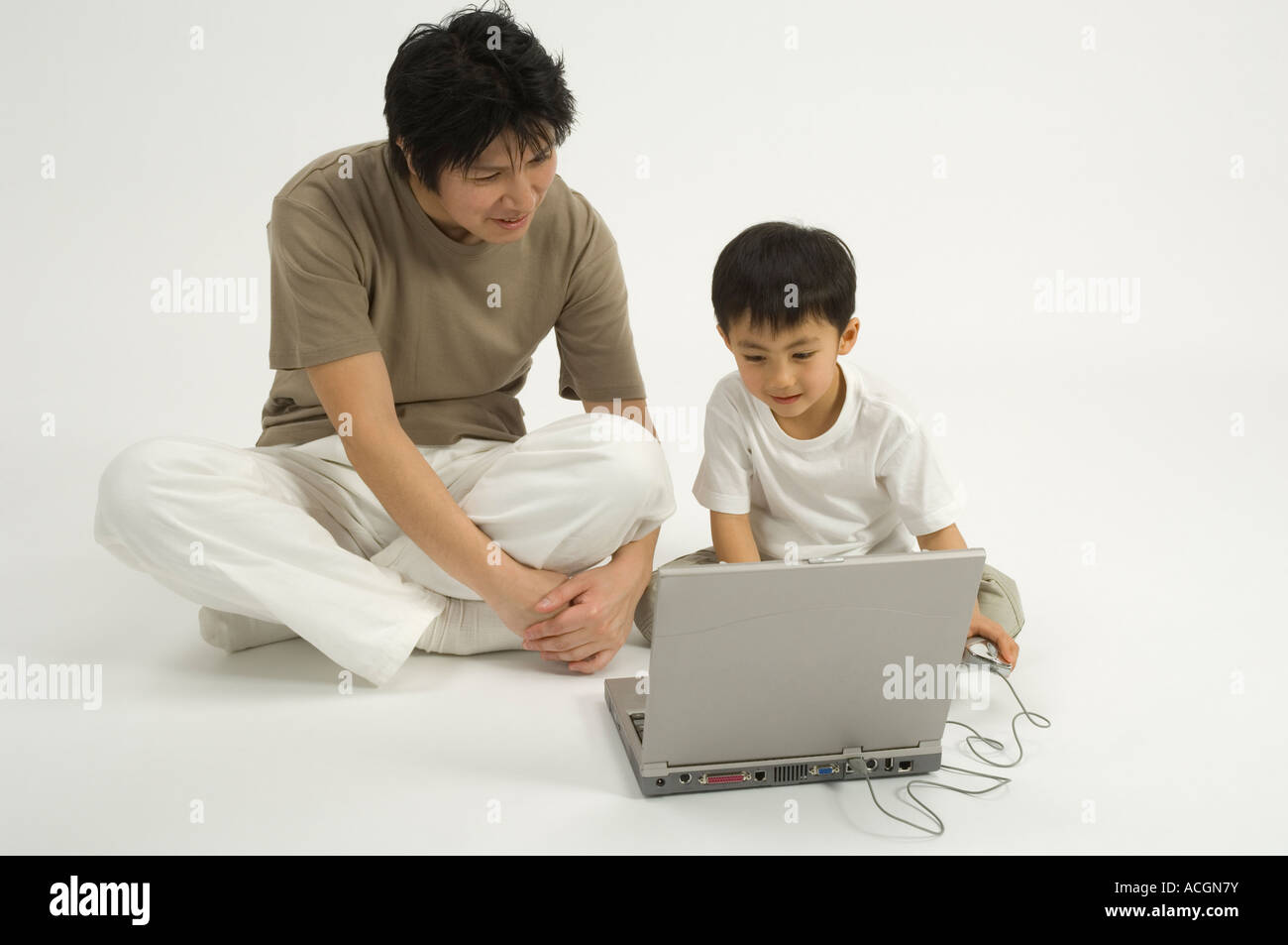Father and son using computer Stock Photo - Alamy
