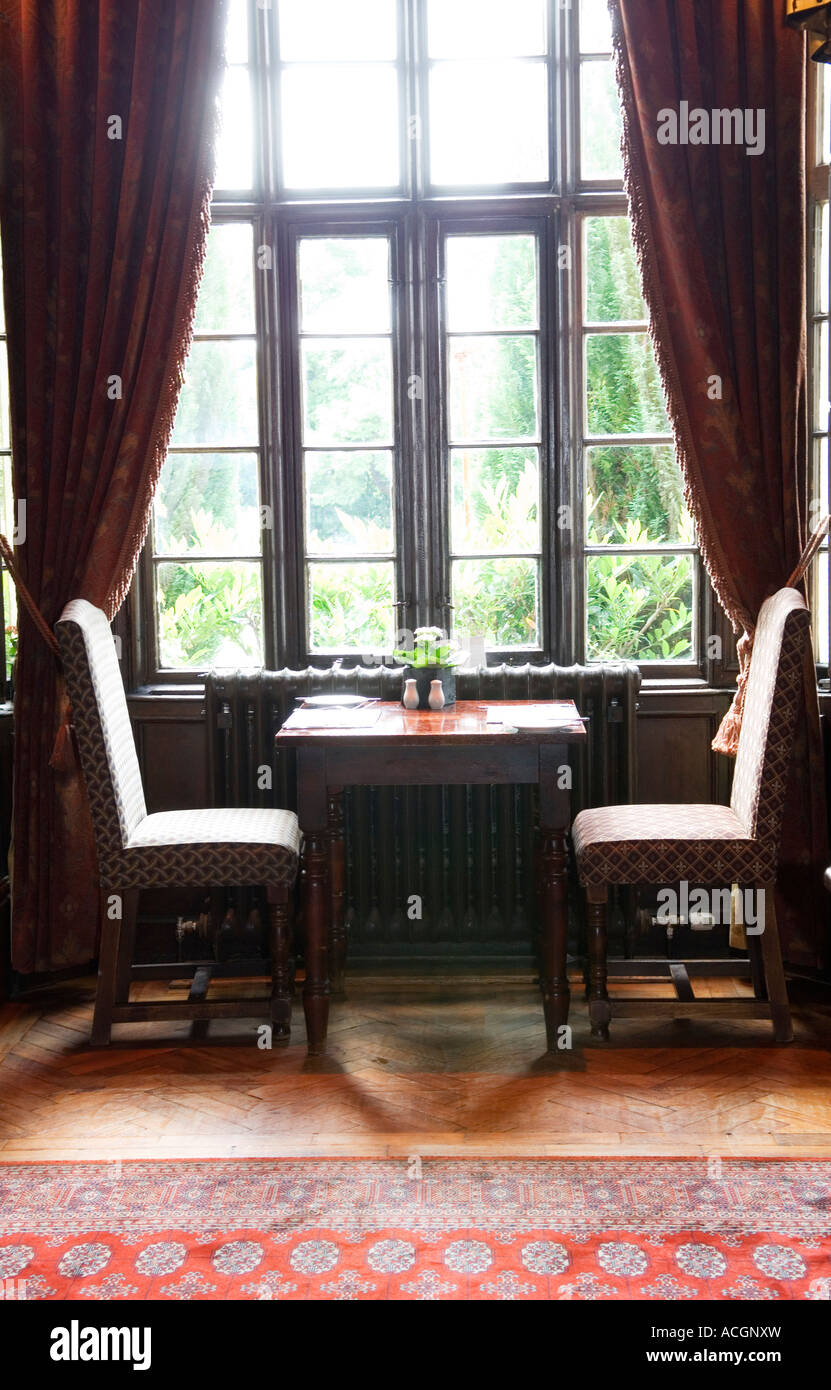 Table by the window set for two at English Country Hotel restaurant ...
