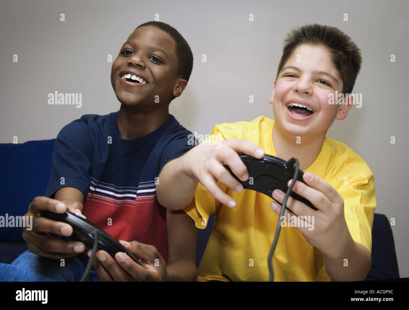 Two boys playing a video game Stock Photo - Alamy