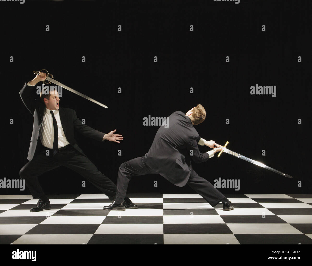 Two businessmen in a sword fight Stock Photo - Alamy