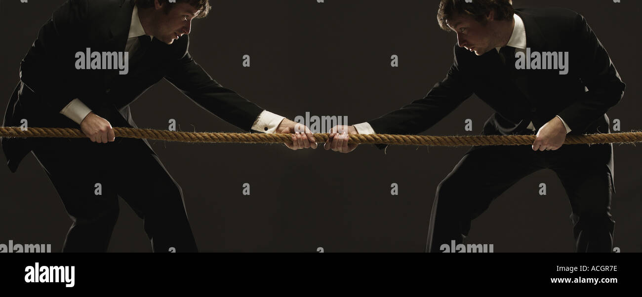Men pulling against each other in a tug of war Stock Photo - Alamy