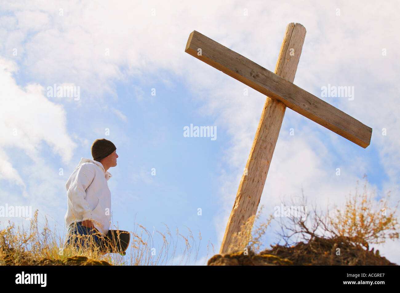 Teenager standing at cross Stock Photo - Alamy