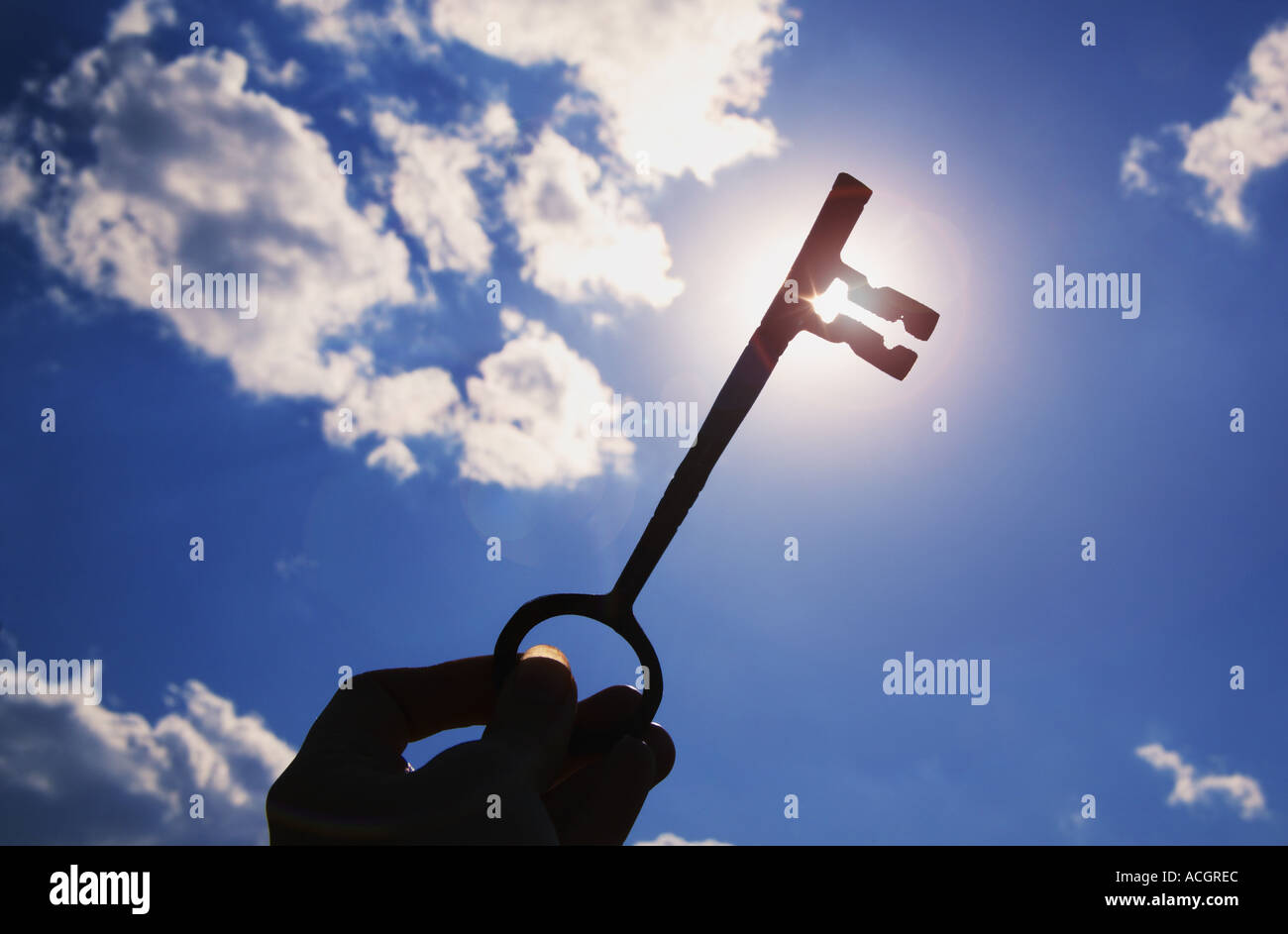 Key held up in sky Stock Photo - Alamy