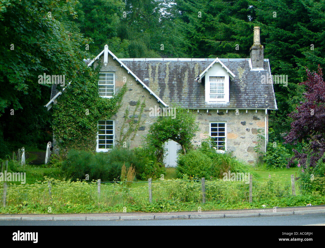 A Scottish cottage set among trees Stock Photo - Alamy