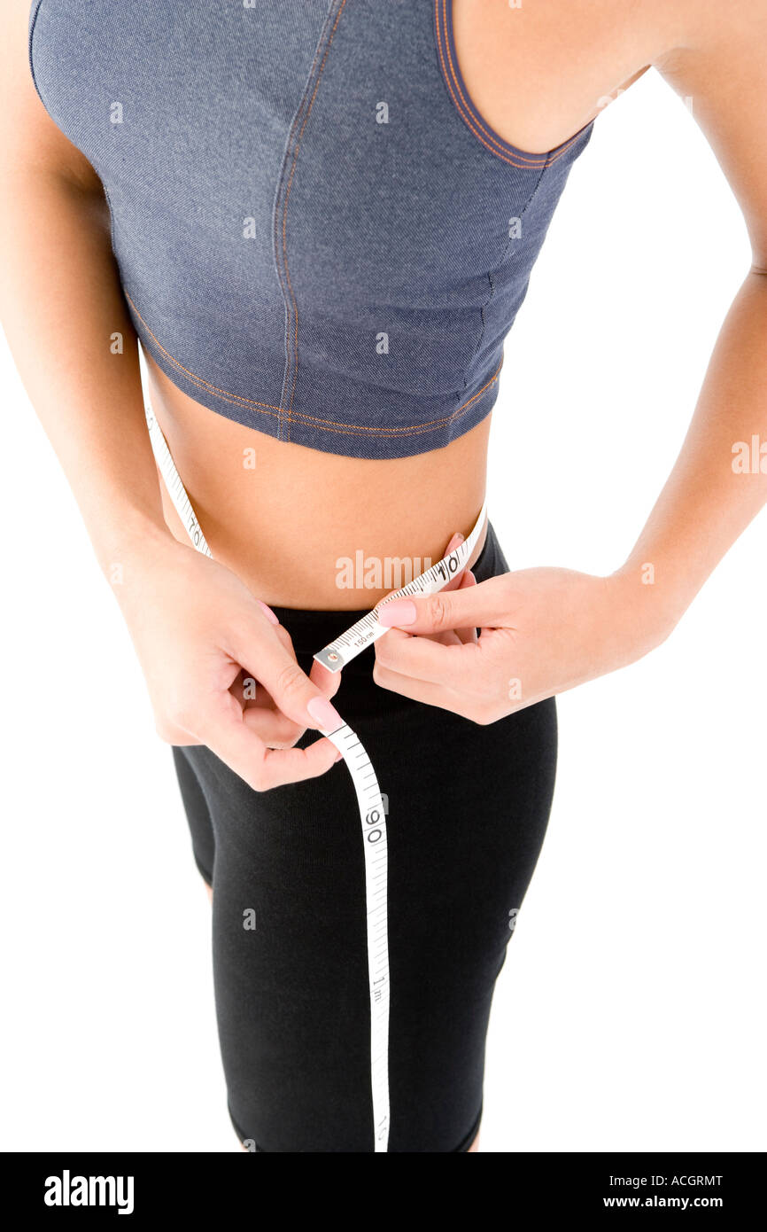 Woman measuring her waist Stock Photo - Alamy