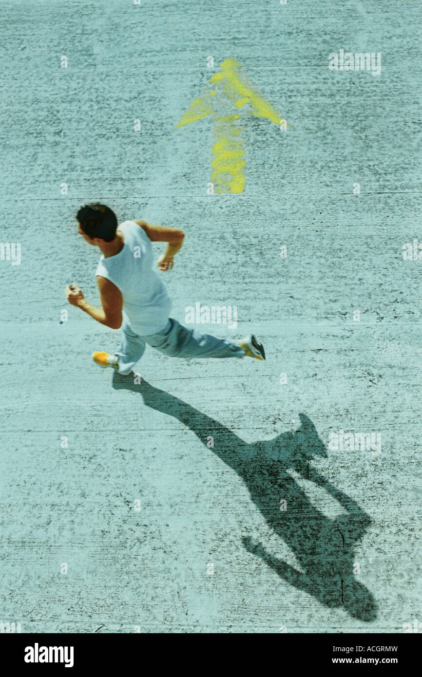 Man running yellow arrow on the floor Stock Photo - Alamy