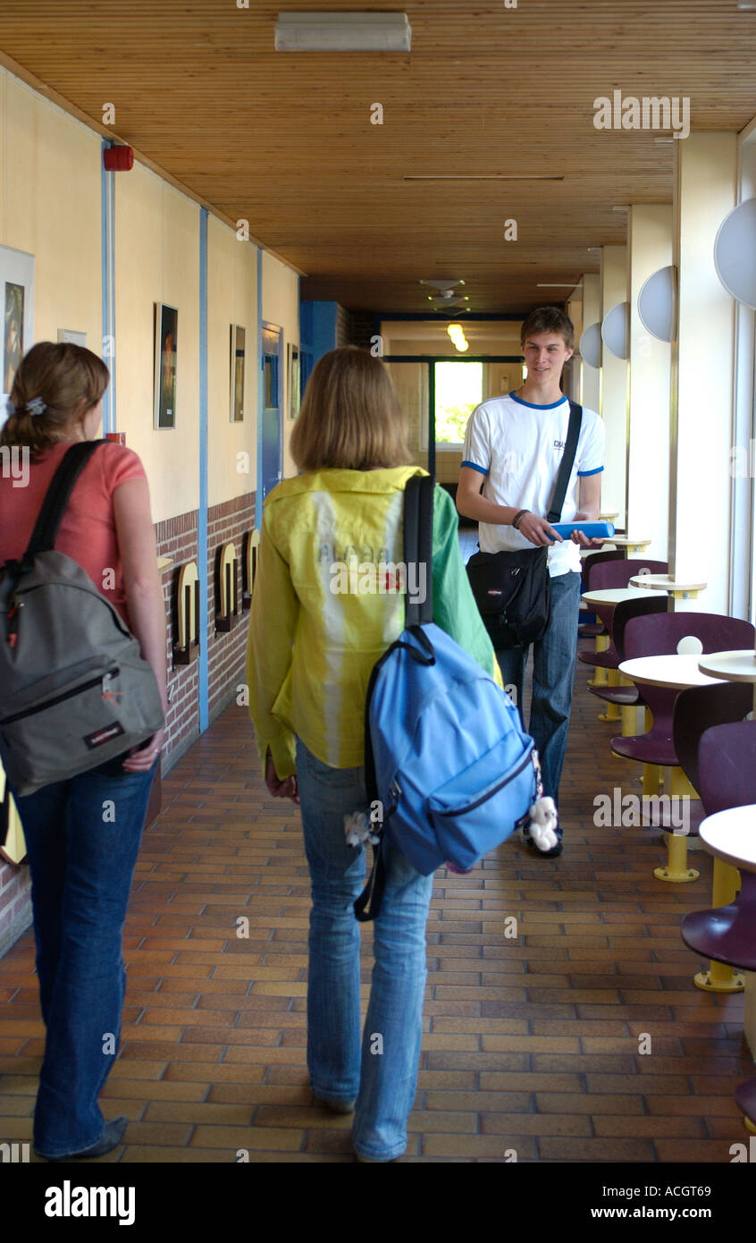 Teenage students walking in school corridor Stock Photo - Alamy