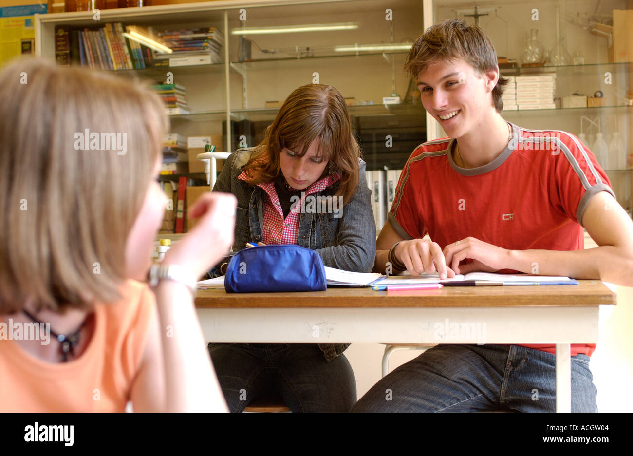 Teenagers talking in classroom Stock Photo - Alamy