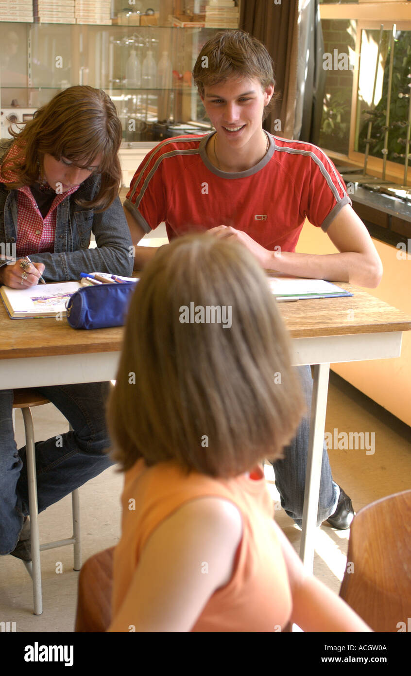 Teenagers talking in classroom Stock Photo - Alamy