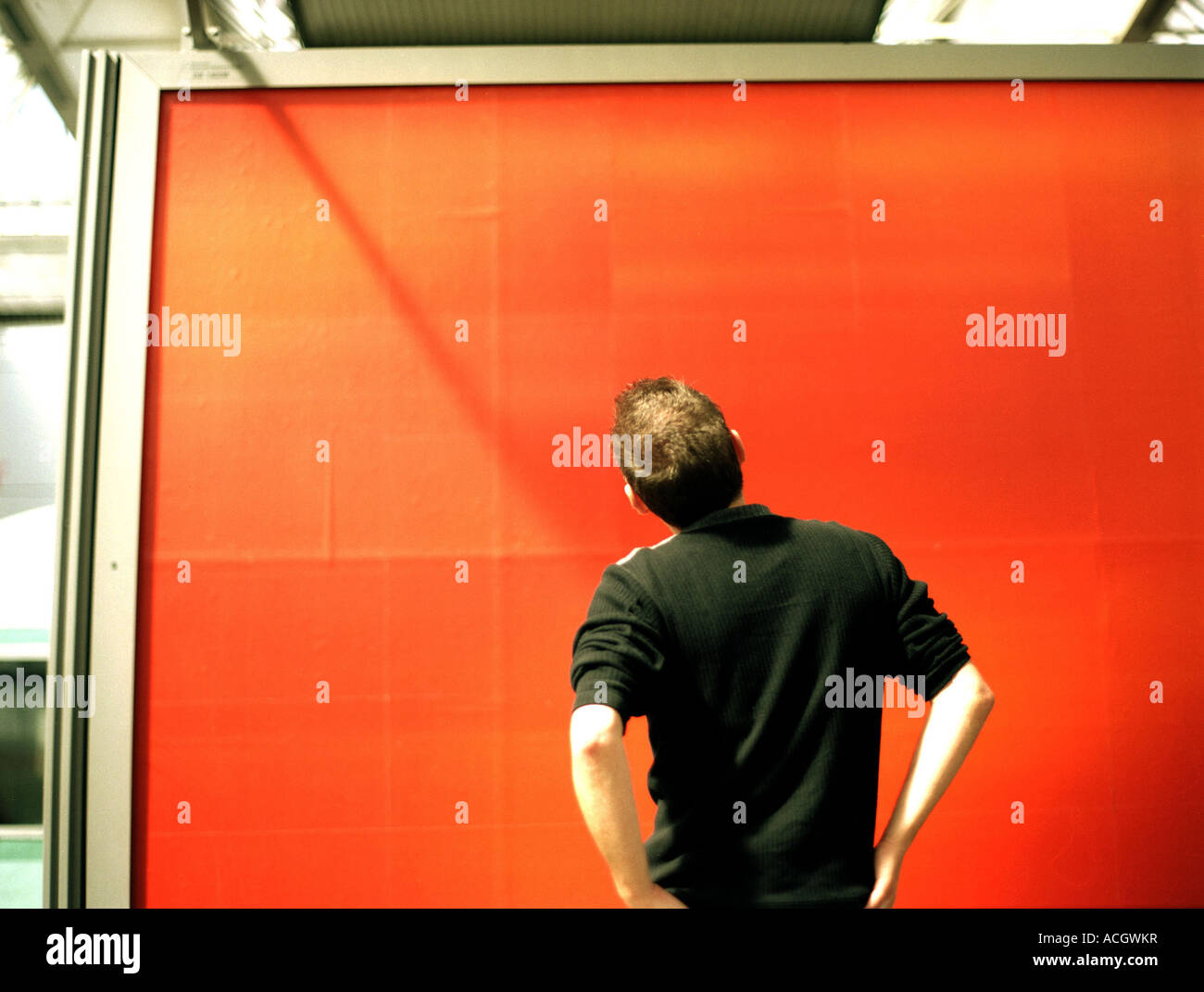 Man looking at big red sign Stock Photo - Alamy