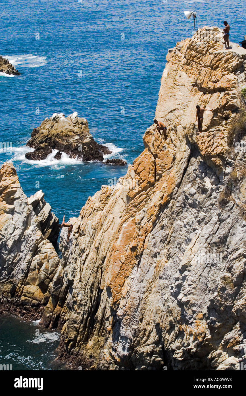 Cliff diving in Acapulco Mexico with diver about to enter the water ...