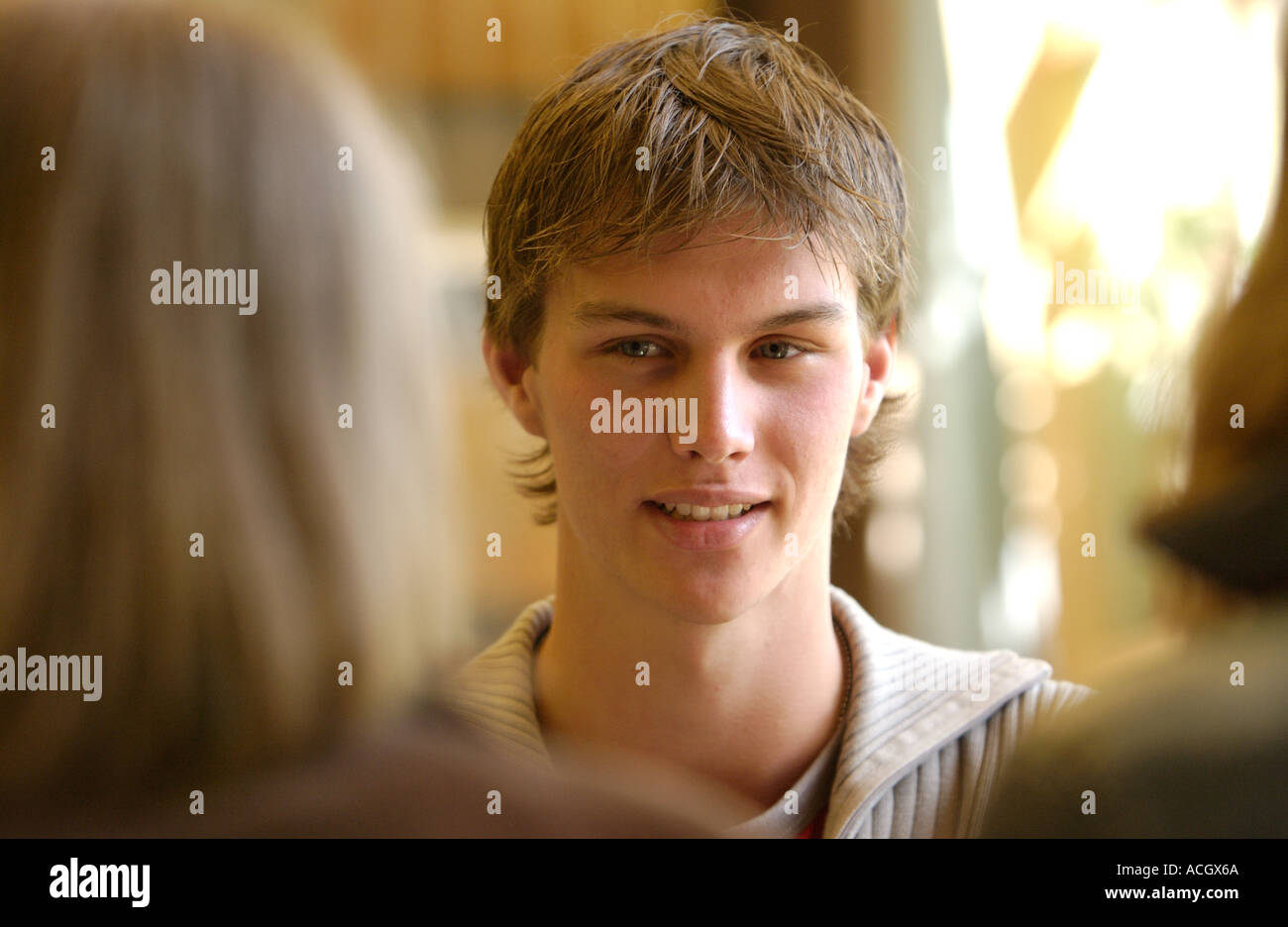 Teenage boy talking to girls Stock Photo - Alamy