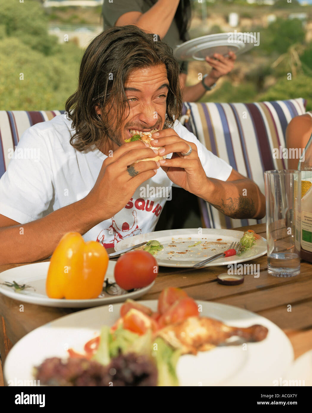 Portrait man eating on terrace Stock Photo - Alamy