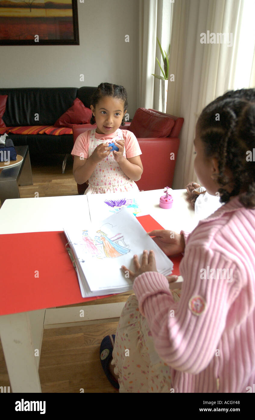 Two girls drawing a picture Stock Photo - Alamy