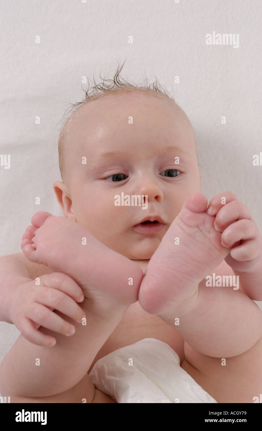 Baby looking at his feet Stock Photo - Alamy