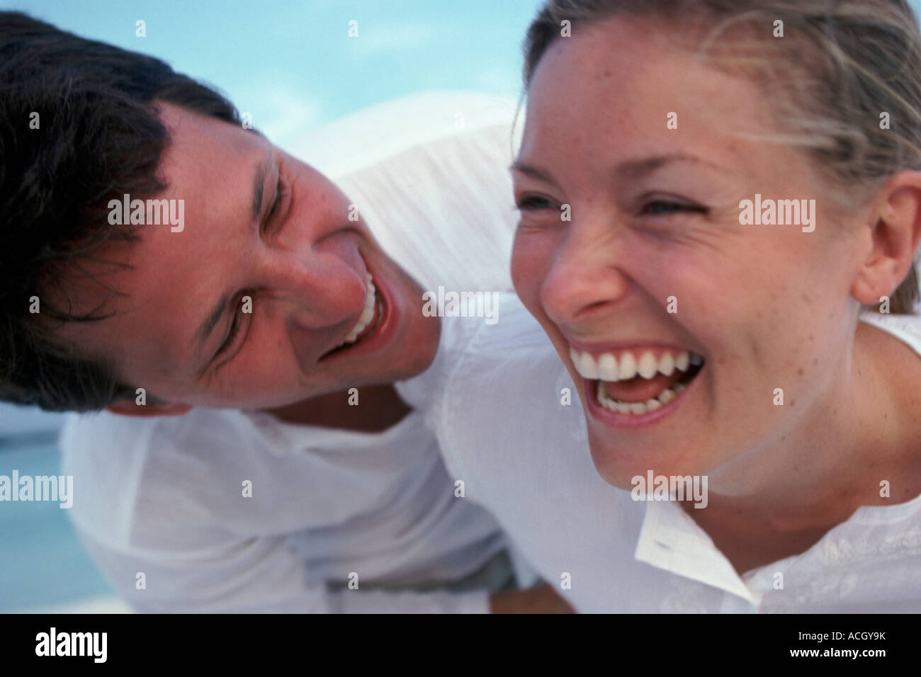 Portrait young couple laughing Stock Photo - Alamy