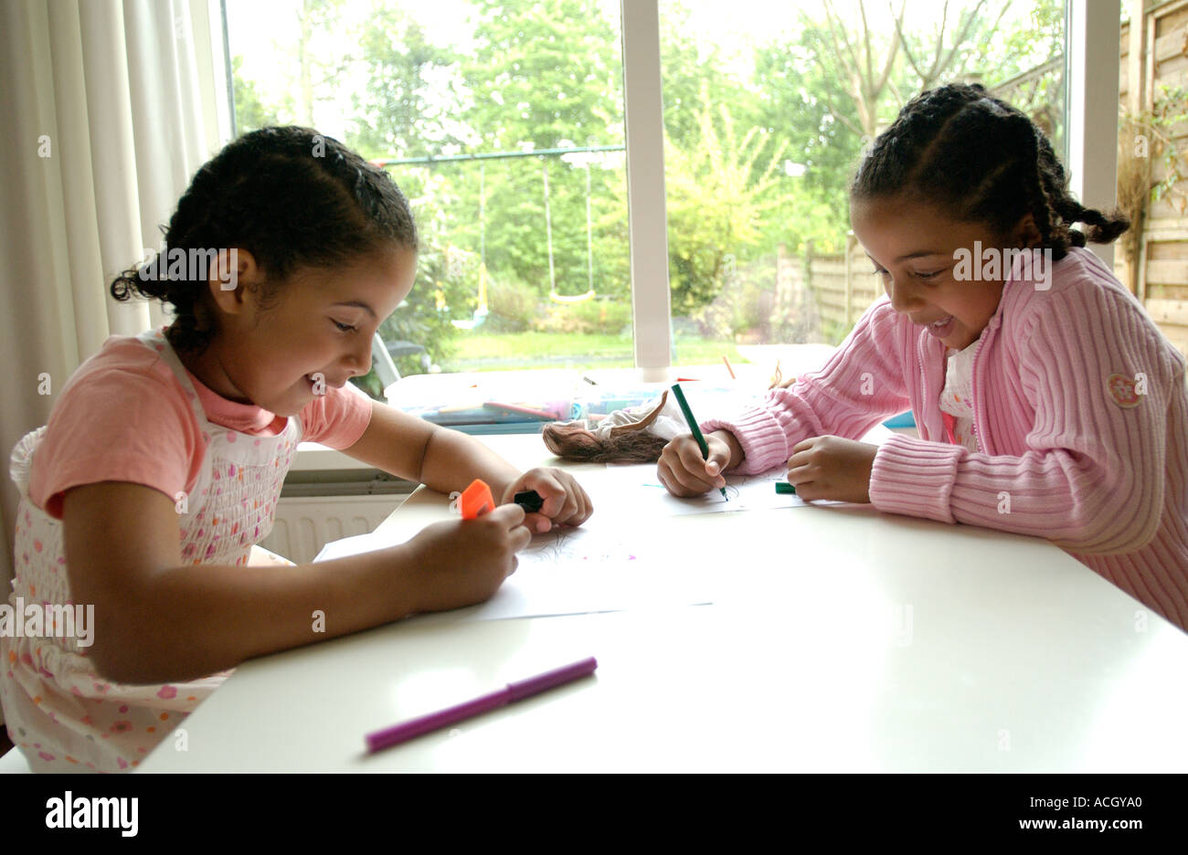 Two girls drawing a picture Stock Photo - Alamy