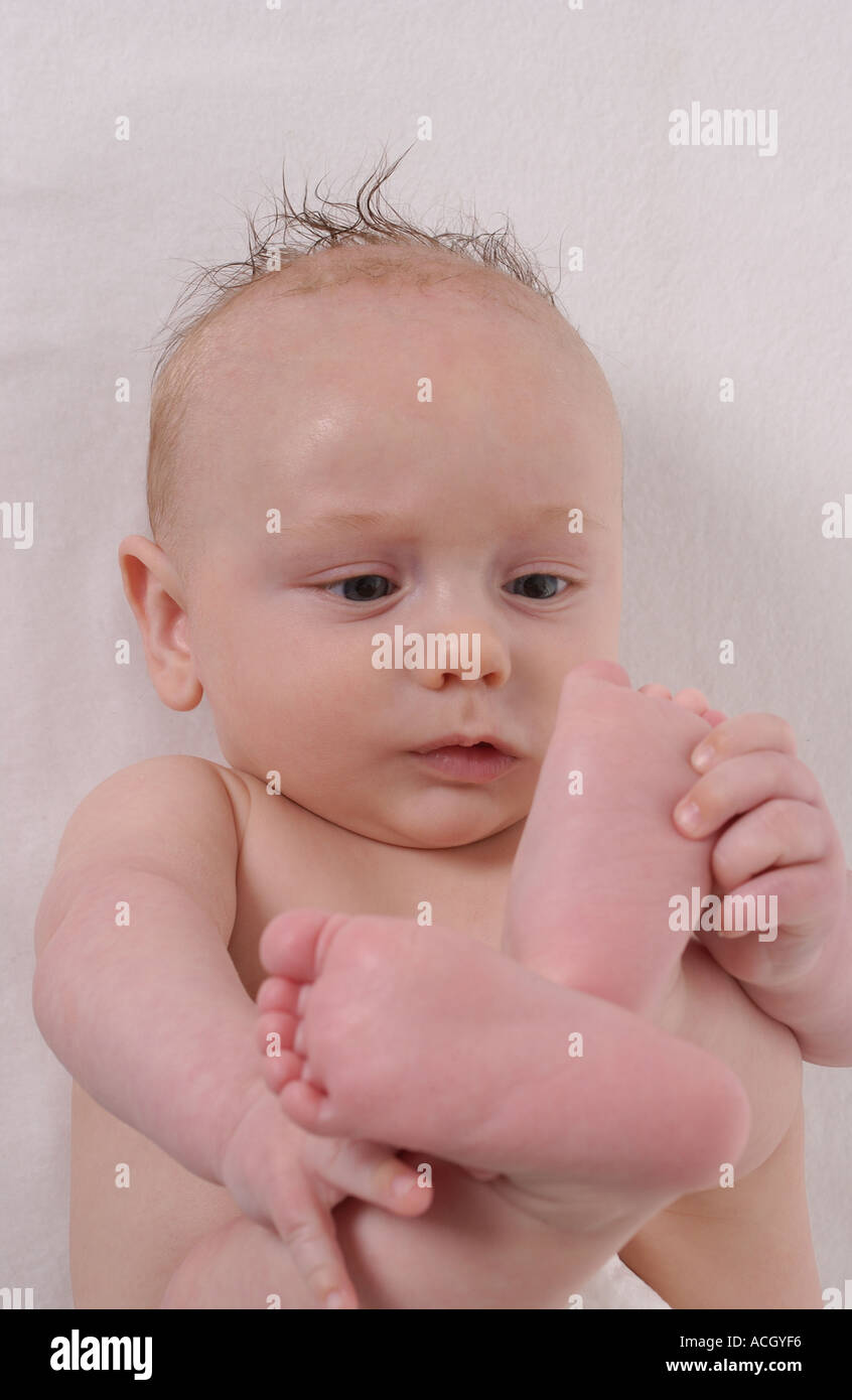 Baby looking at his feet Stock Photo - Alamy