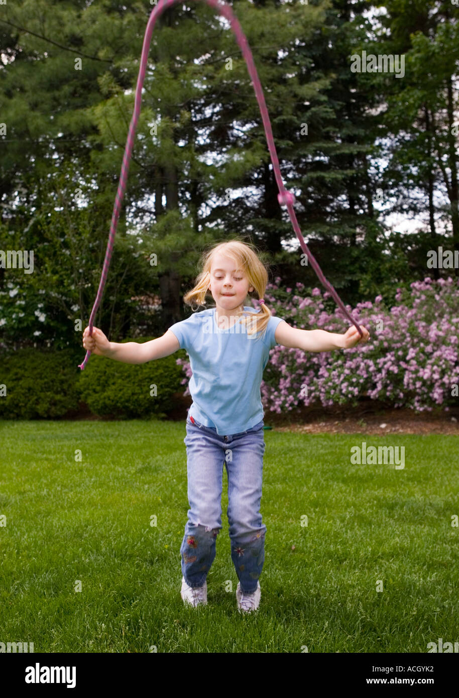 Young child jumping rope Stock Photo - Alamy