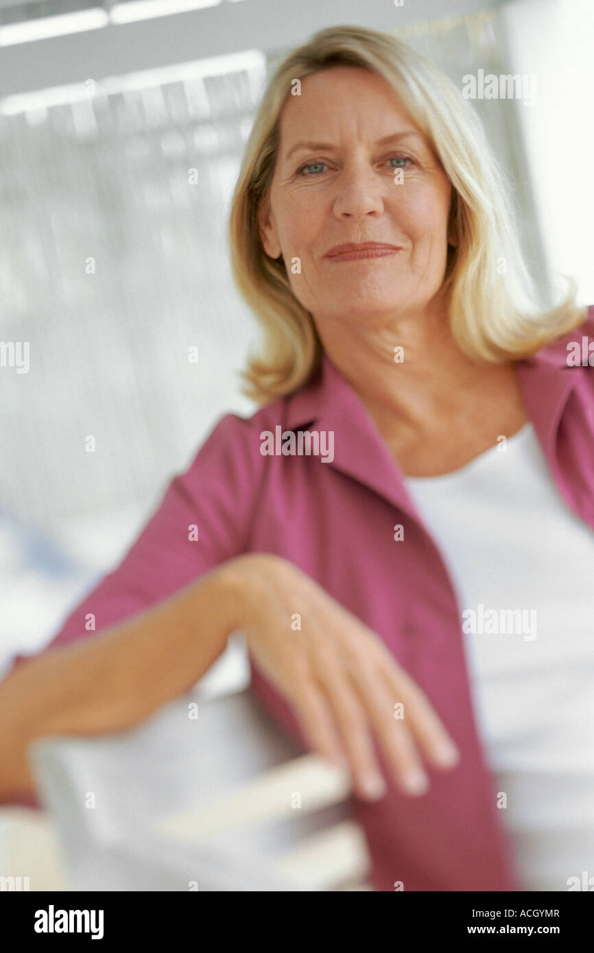 Portrait smiling woman sitted in armchair on terrace Stock Photo - Alamy