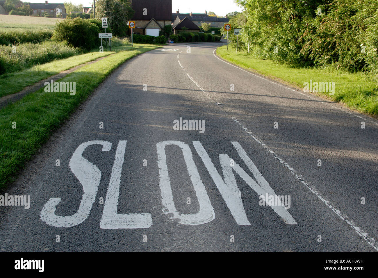 Slow sign on road entering Stoke Goldington, Buckinghamshire, England ...