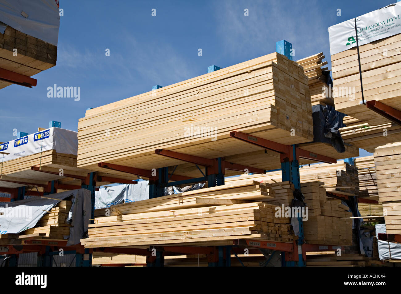 Sawn and planed timber on racks in builders merhcant yard England UK ...