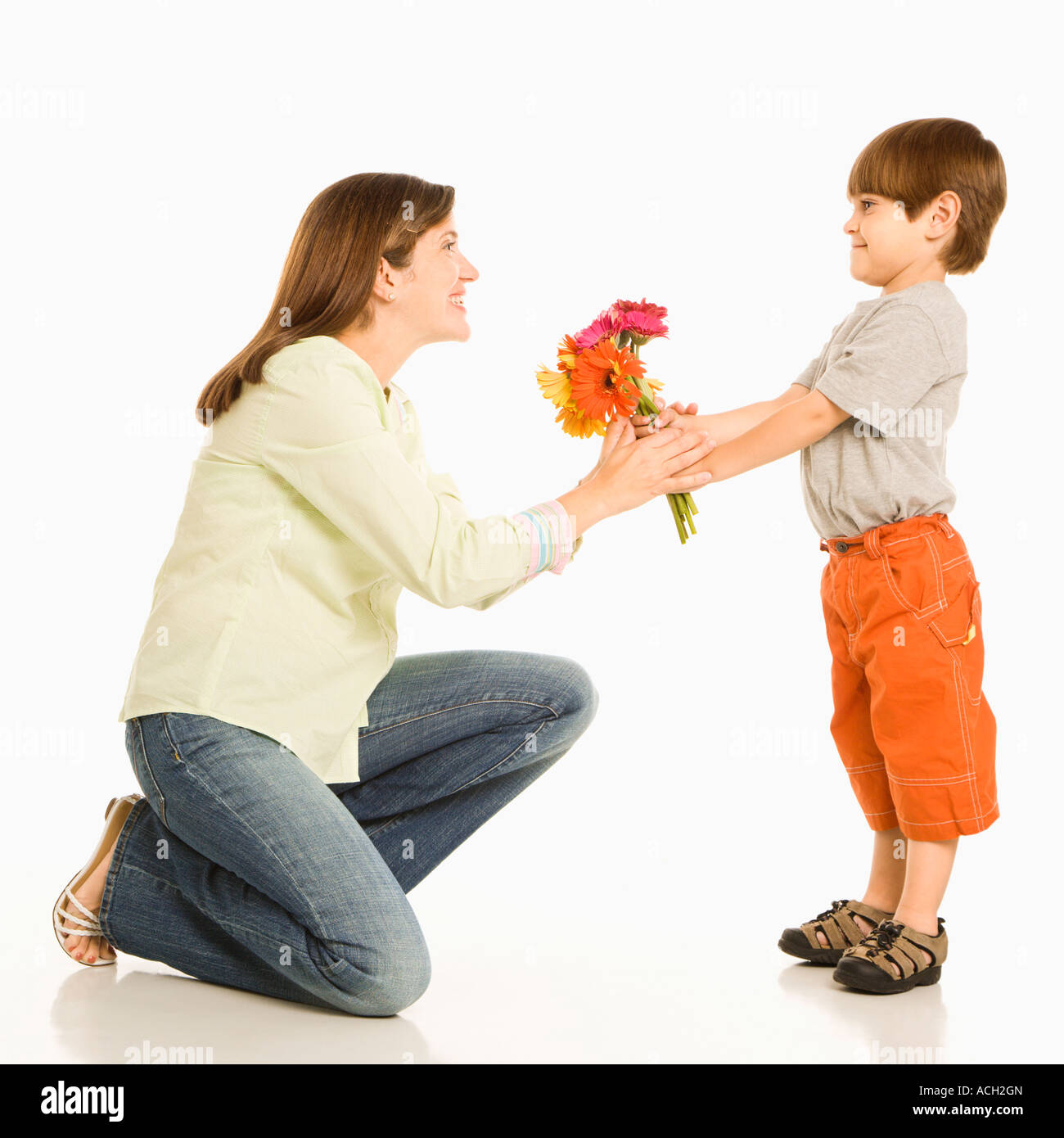 Son giving bouquet of flowers to mother Stock Photo - Alamy