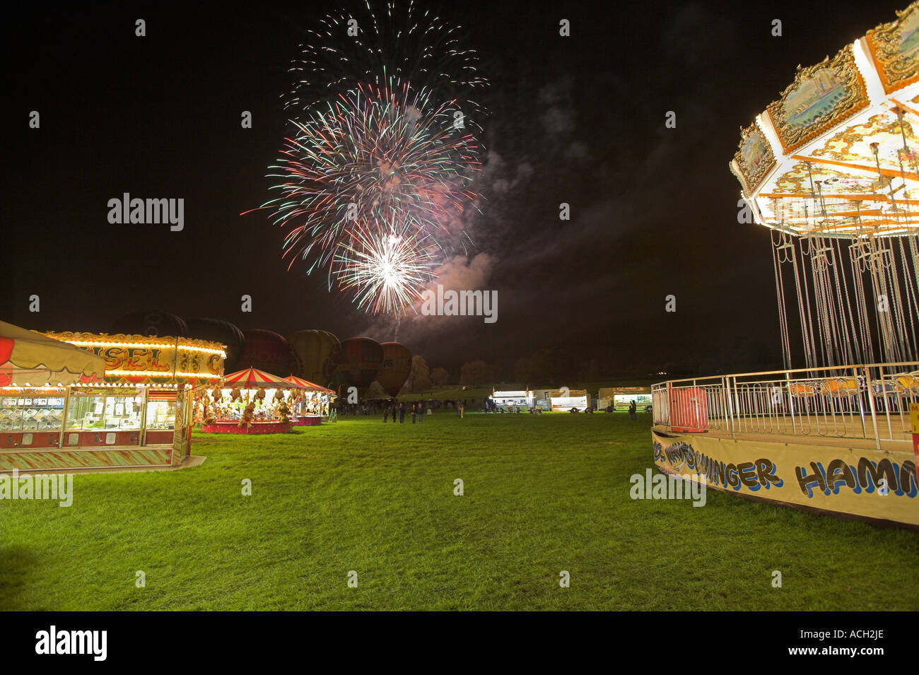 Fireworks bursting over funfair at balloon spectacular Surrey Stock ...