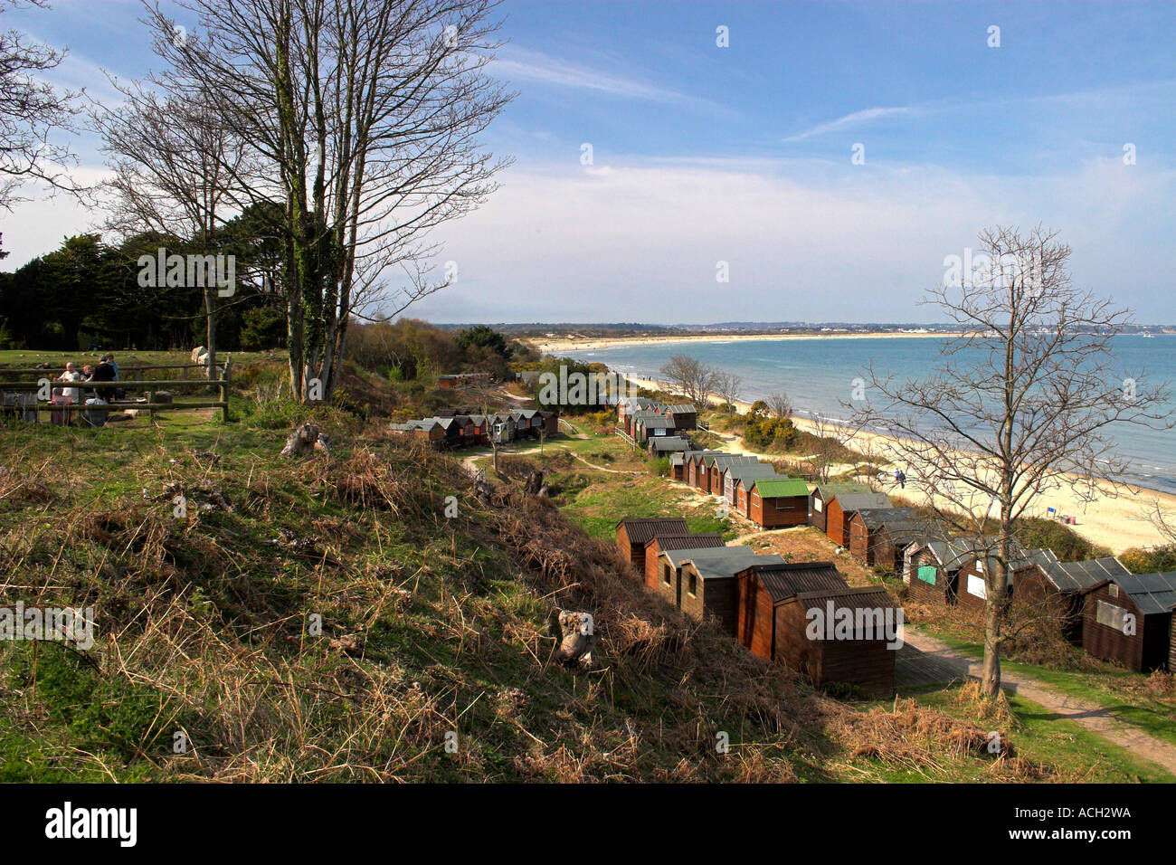 Beach huts and countryside looking across Studland and Shell Bay ...