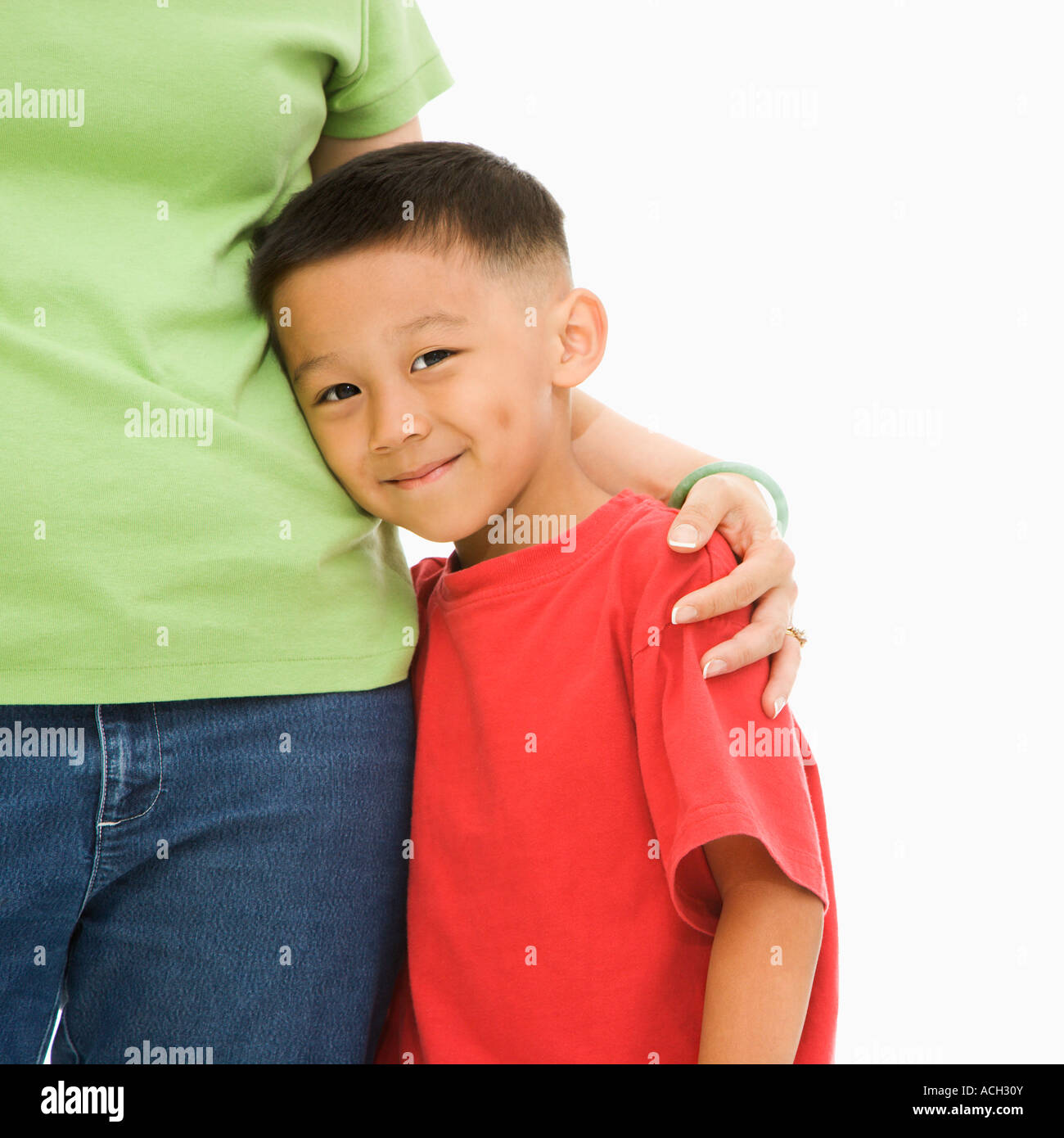 Asian mother standing with arm around son Stock Photo - Alamy