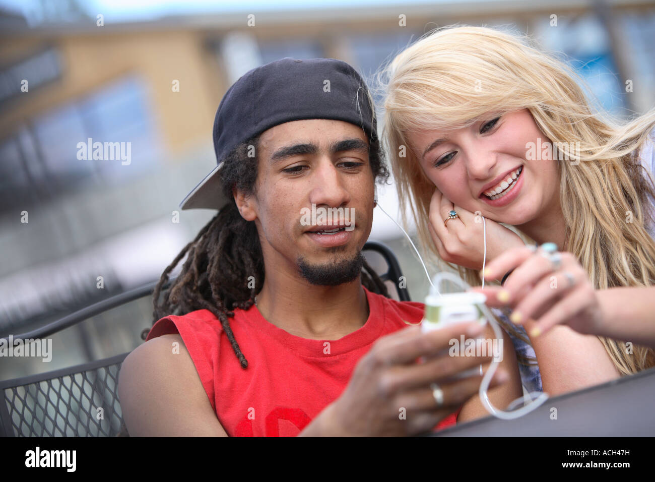 Couple sharing earbuds hi-res stock photography and images - Alamy