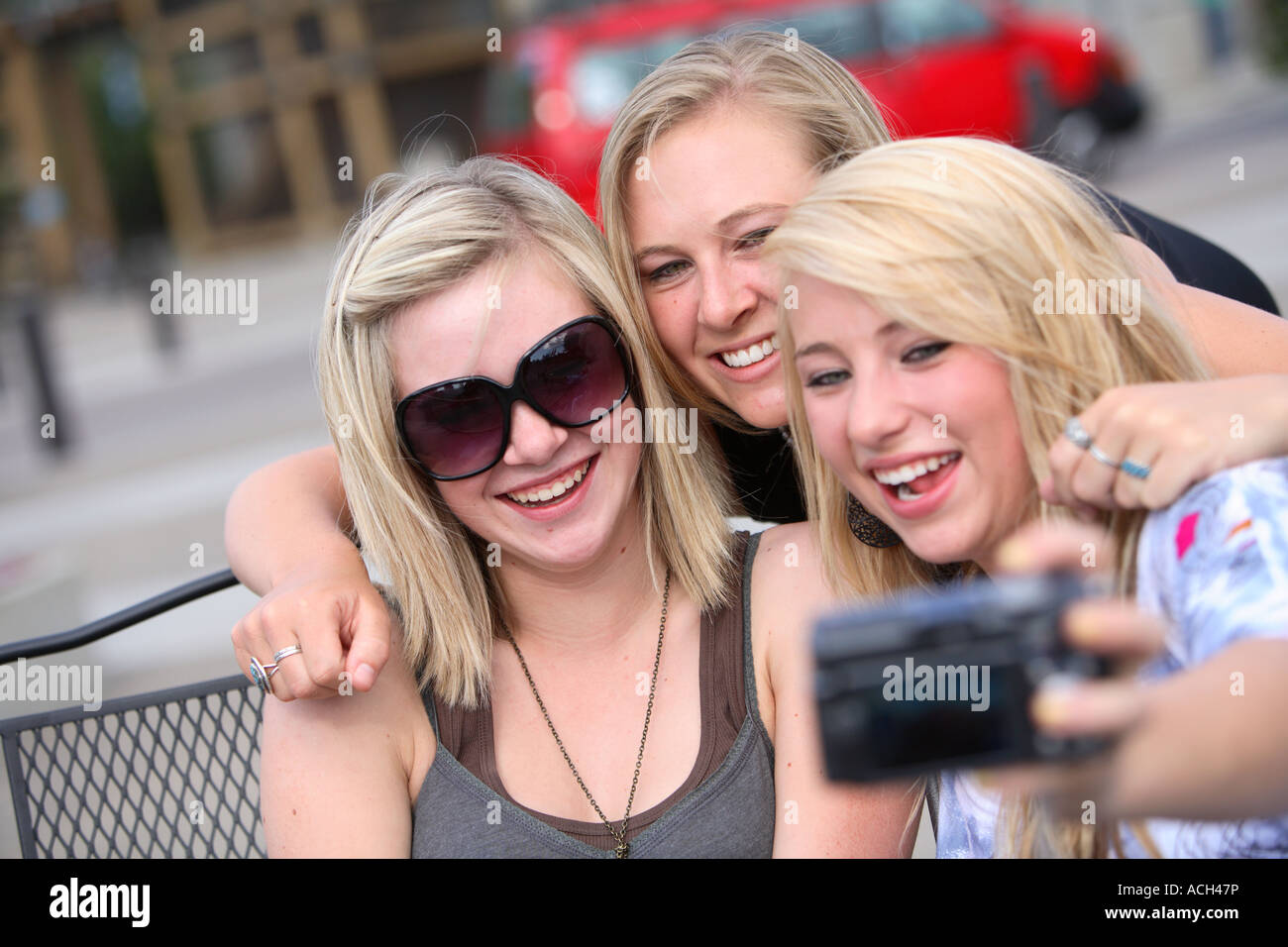 Three girls talking a picture together Stock Photo - Alamy
