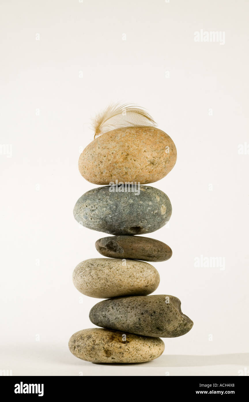 Stack of balanced rocks with feather on top Stock Photo - Alamy