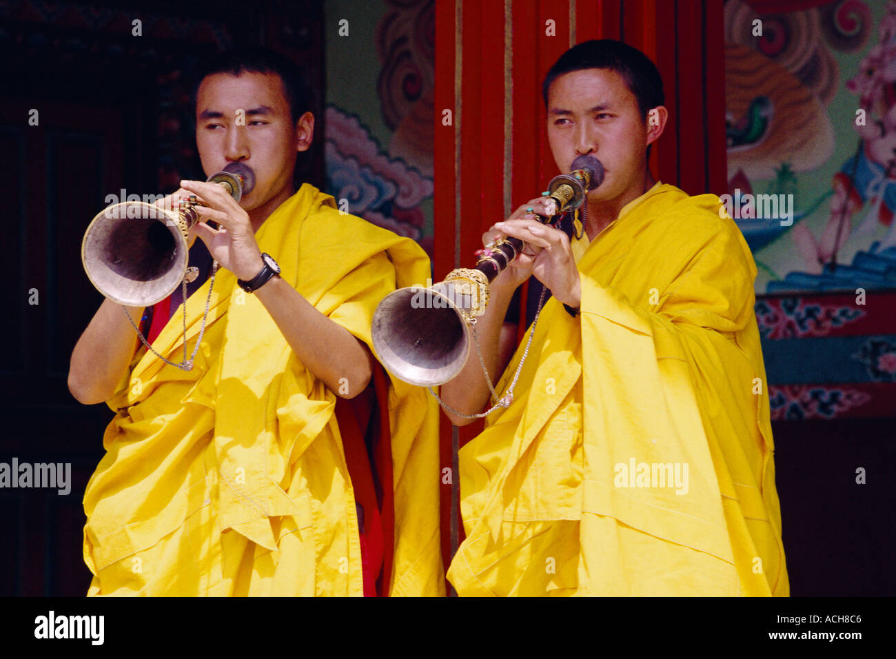 Monks blowing flutes outside a gompa Tibetan monastery Bodhnath ...