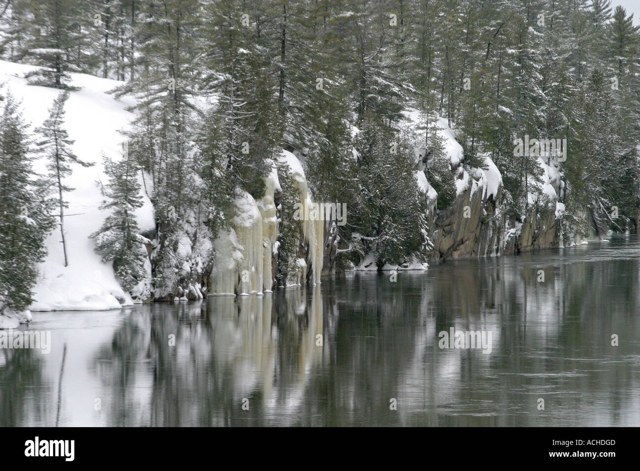 ice and snow off rock cliffs by river Stock Photo - Alamy