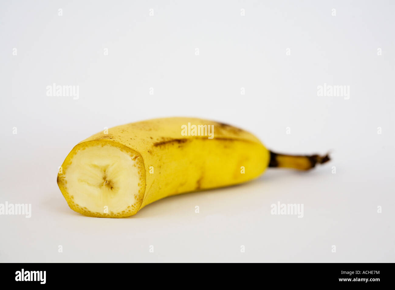 Banana cut open to reveal inside on white background Stock Photo - Alamy