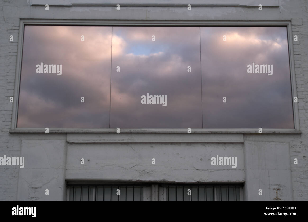 Sky reflection in a mirrored window Stock Photo - Alamy