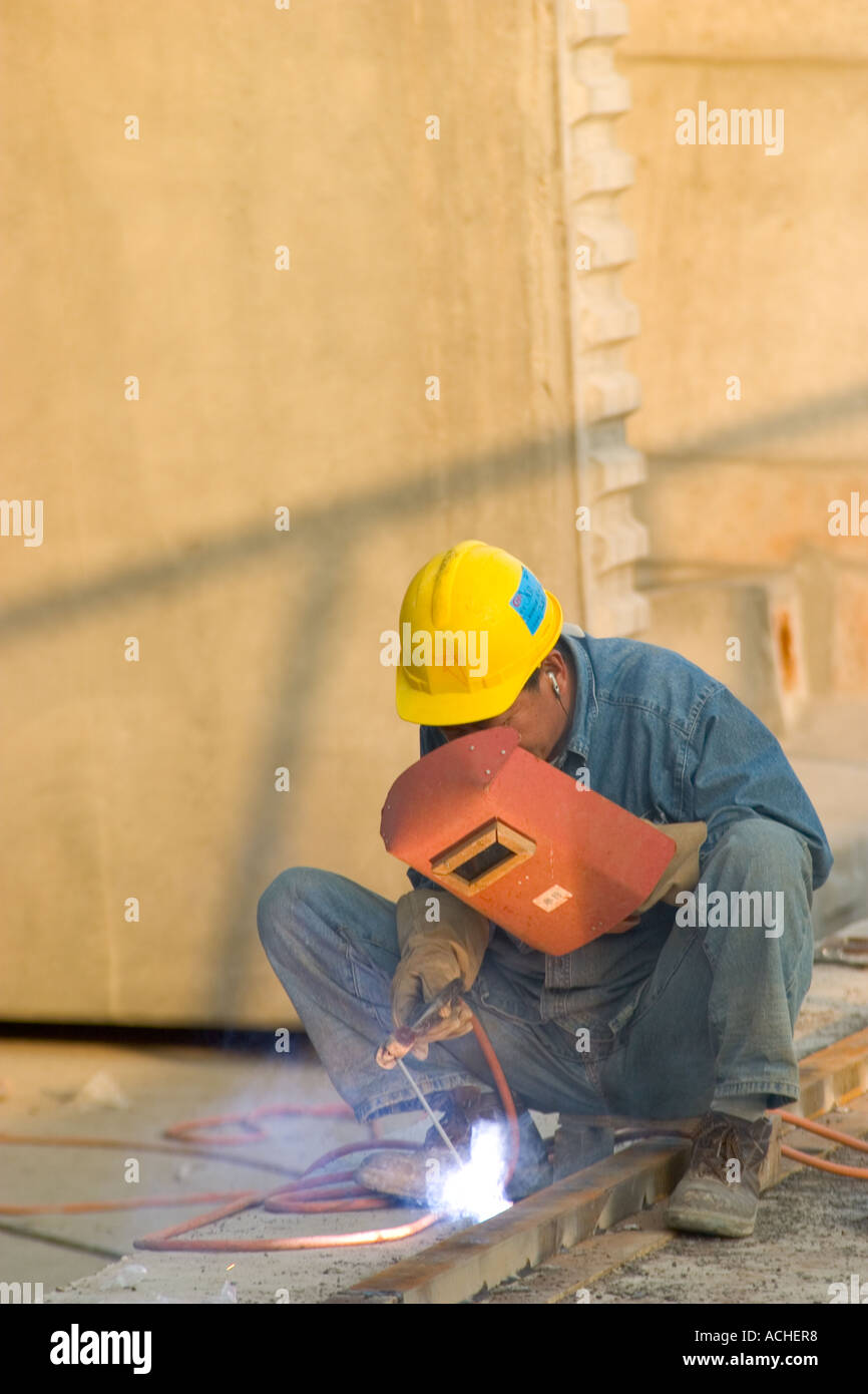 Welder working with electric arc welder Stock Photo - Alamy