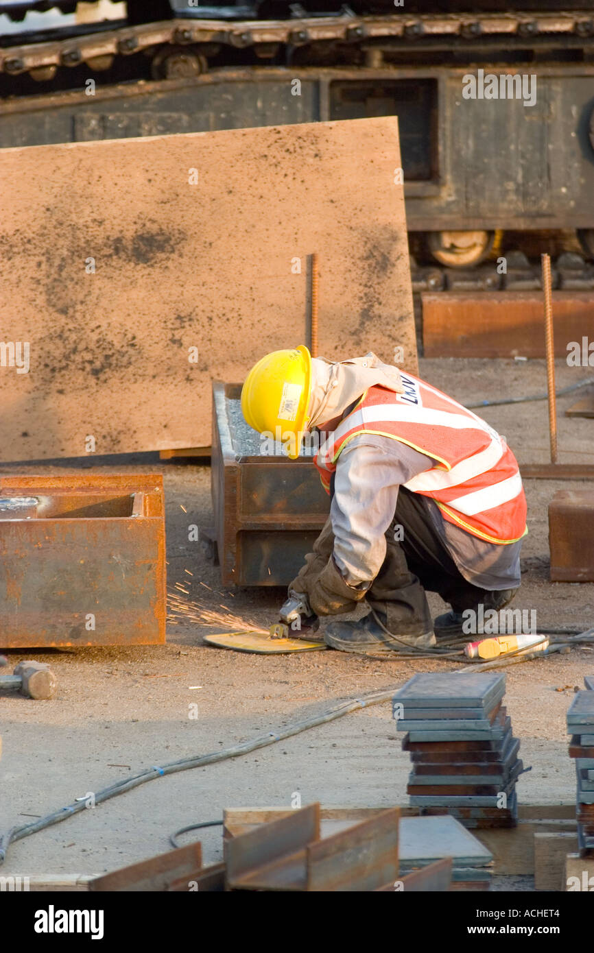Metal Construction worker working with grinder Stock Photo - Alamy