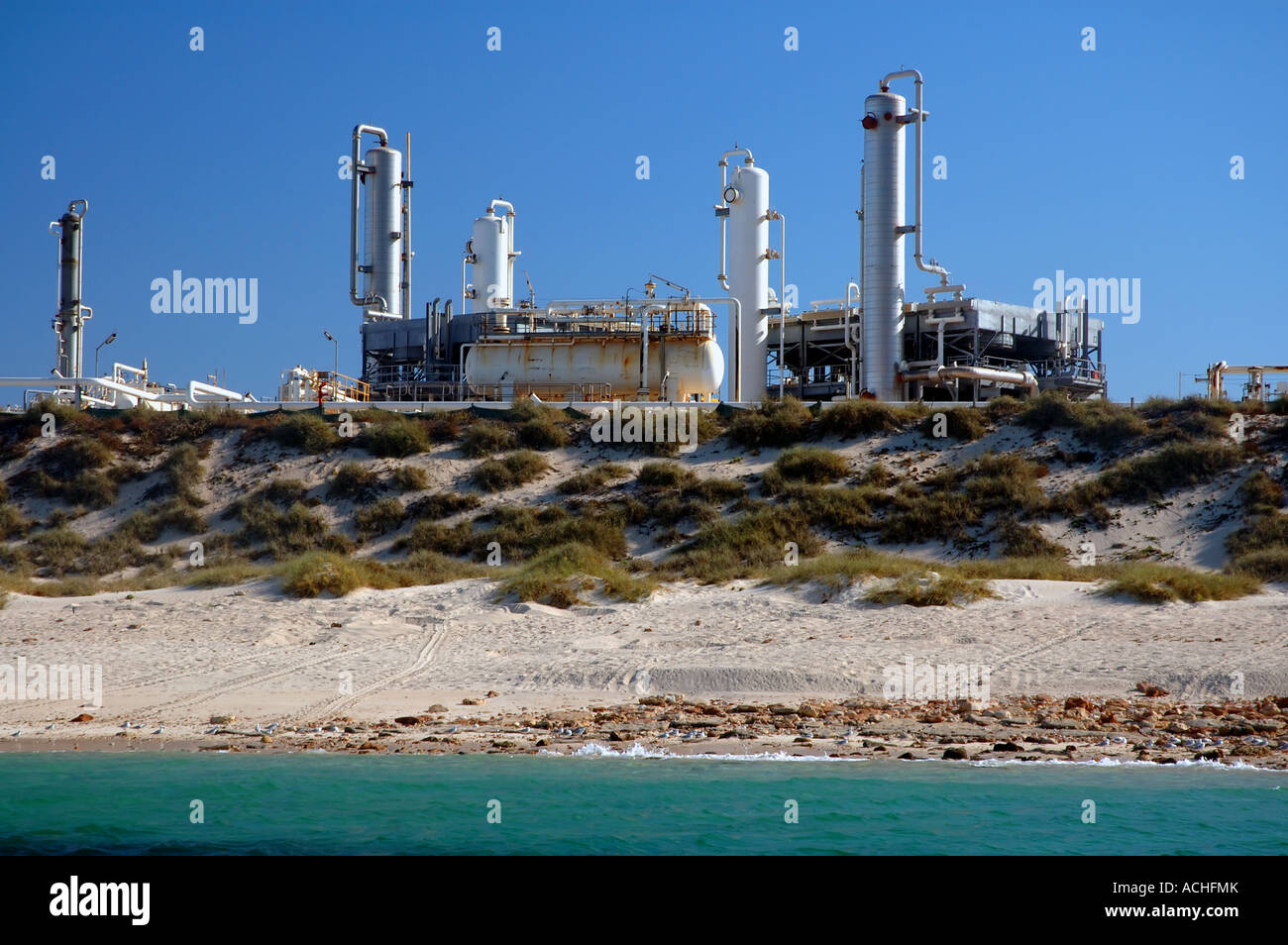 Numerous tracks of nesting sea turtles on beach below industrial ...